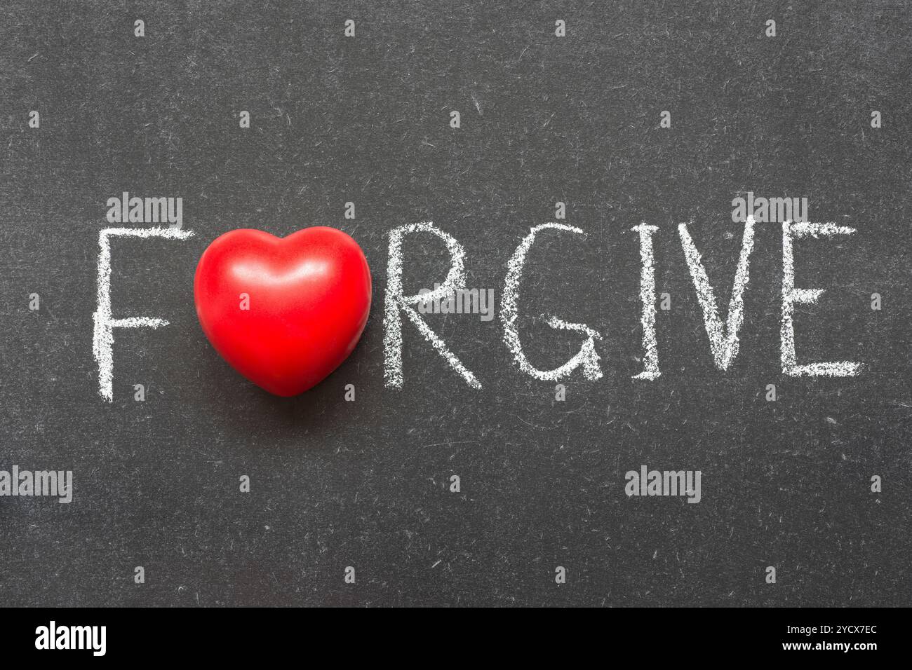 forgive word handwritten on chalkboard with heart symbol instead of O ...