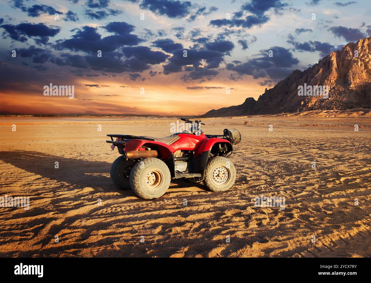 Quad bike in sand desert Stock Photo - Alamy