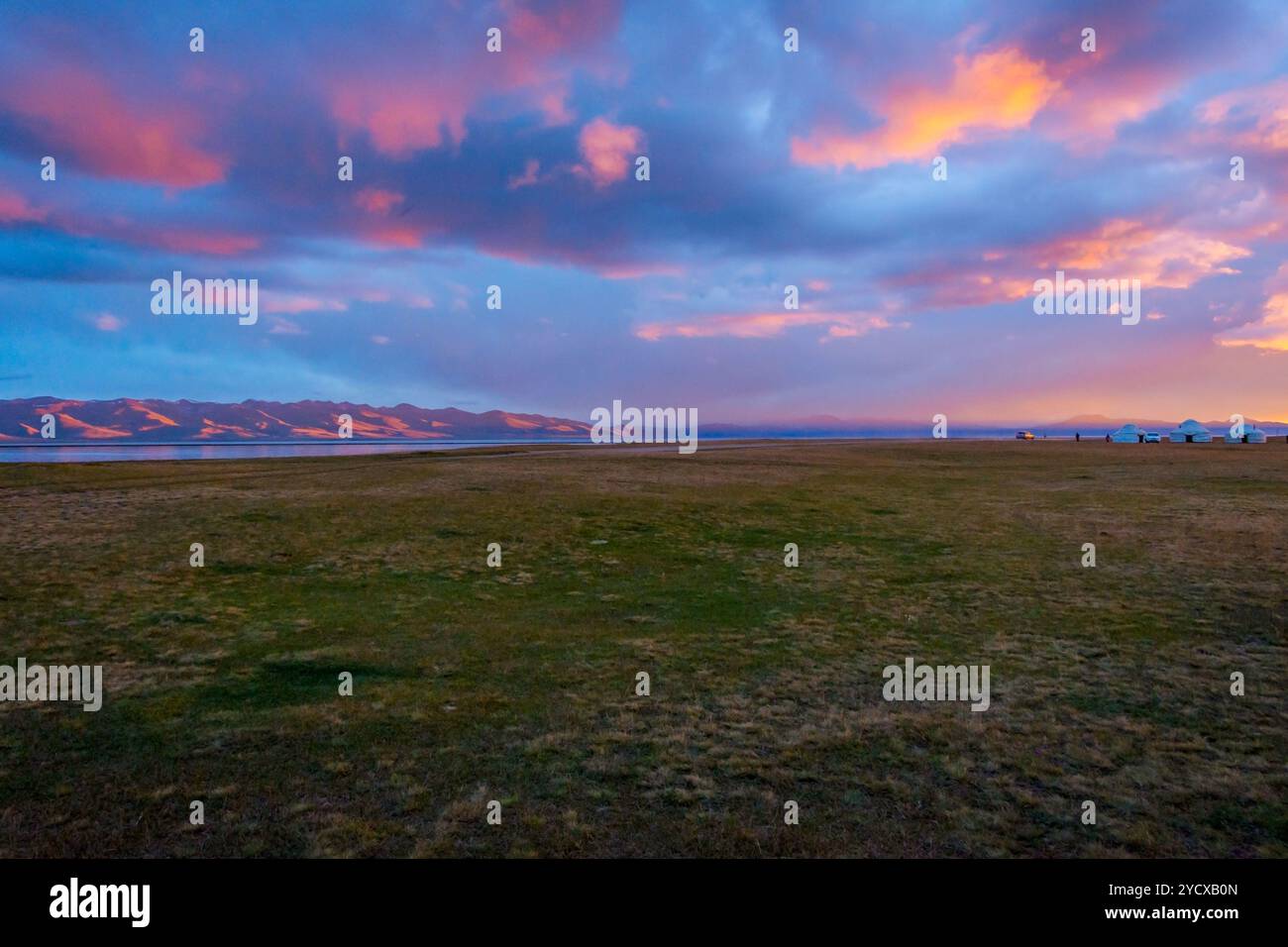 Yurts and mountains around Song Kul lake in a sunset light, Kyrgyzstan ...