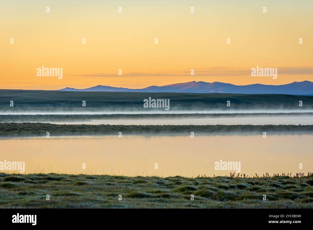 Song Kul lake in mist in early morning light, Kyrgyzstan Stock Photo ...