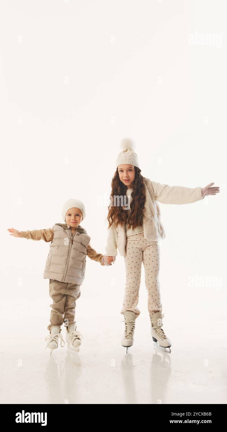 Hand in hand, brother and sister glide across ice, making most of their ...