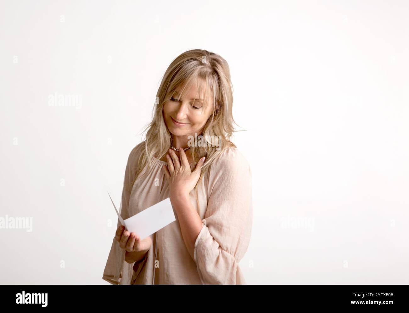 Woman reading a heartfelt message note or card Stock Photo - Alamy