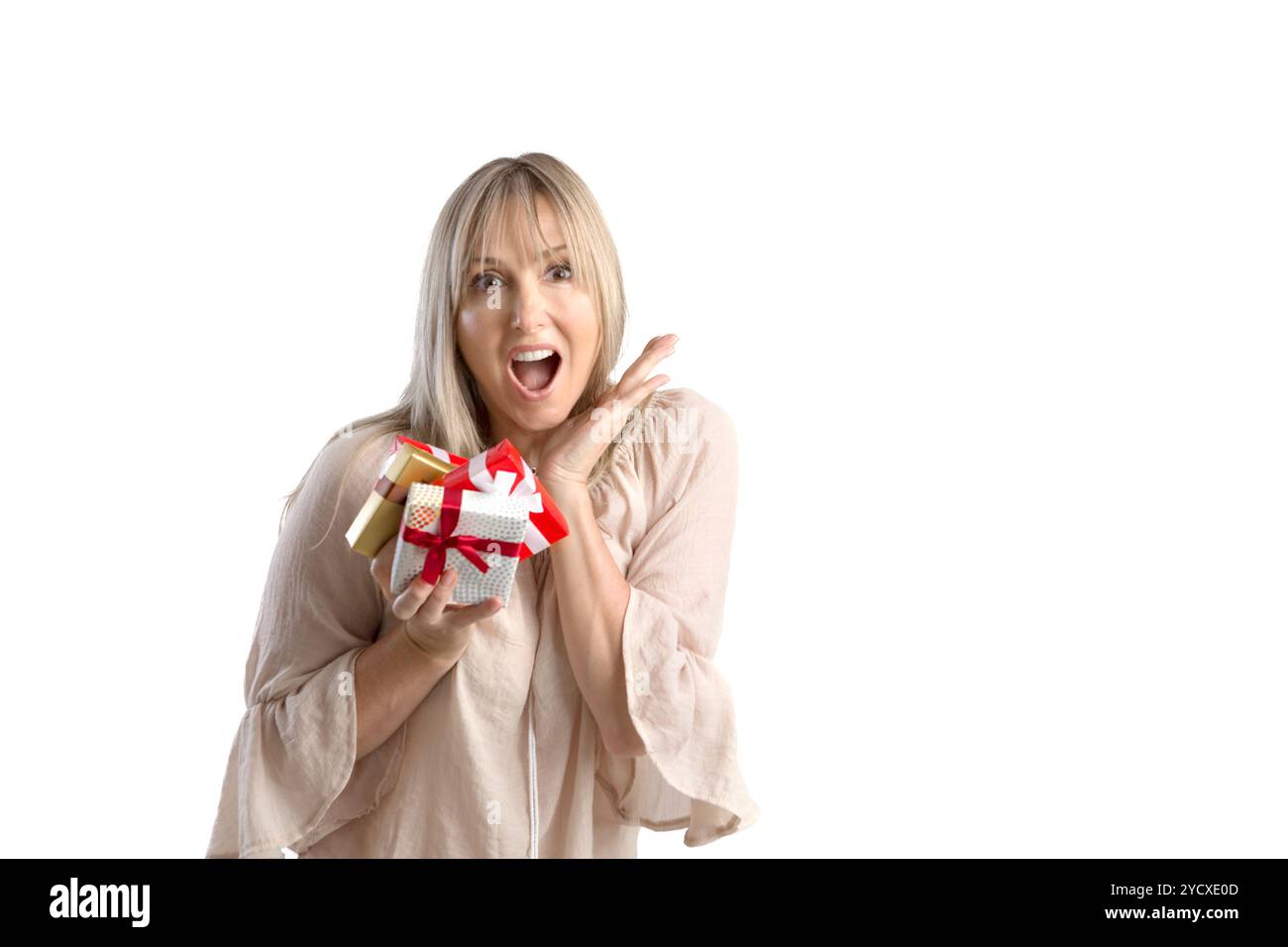 Surprised woman holding wrapped gifts on white background Stock Photo ...