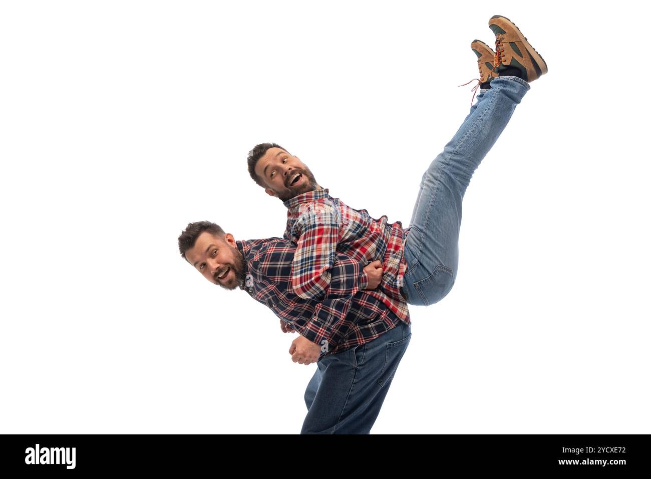 Two brothers, twins, dressed matching casual outfits, having fun ...