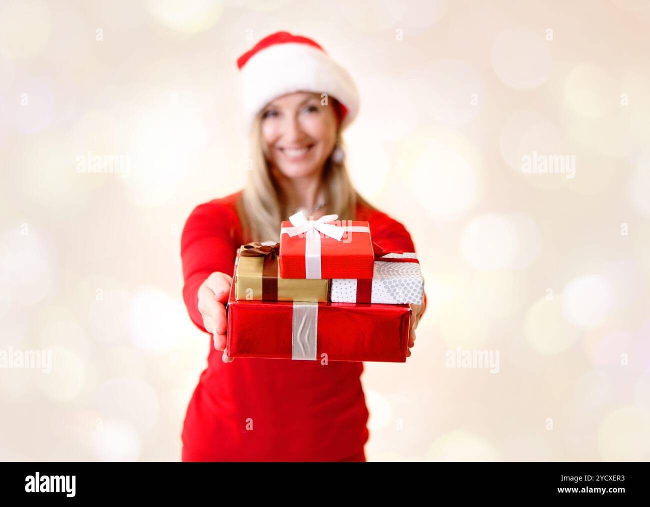 Woman santa hat giving presents hi-res stock photography and images - Alamy