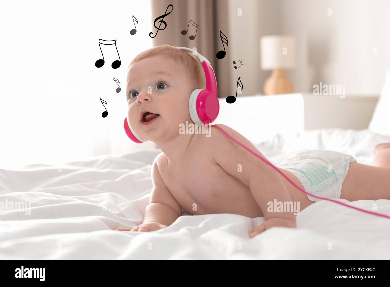 Cute little baby with headphones on bed at home. Music notes flying ...