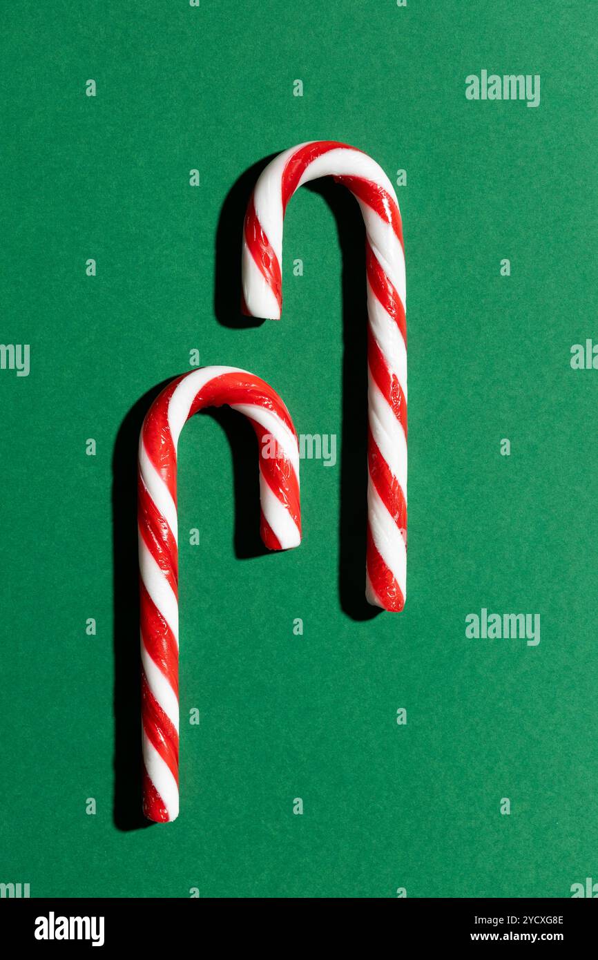 Top view of two intertwined red and white striped candy canes ...