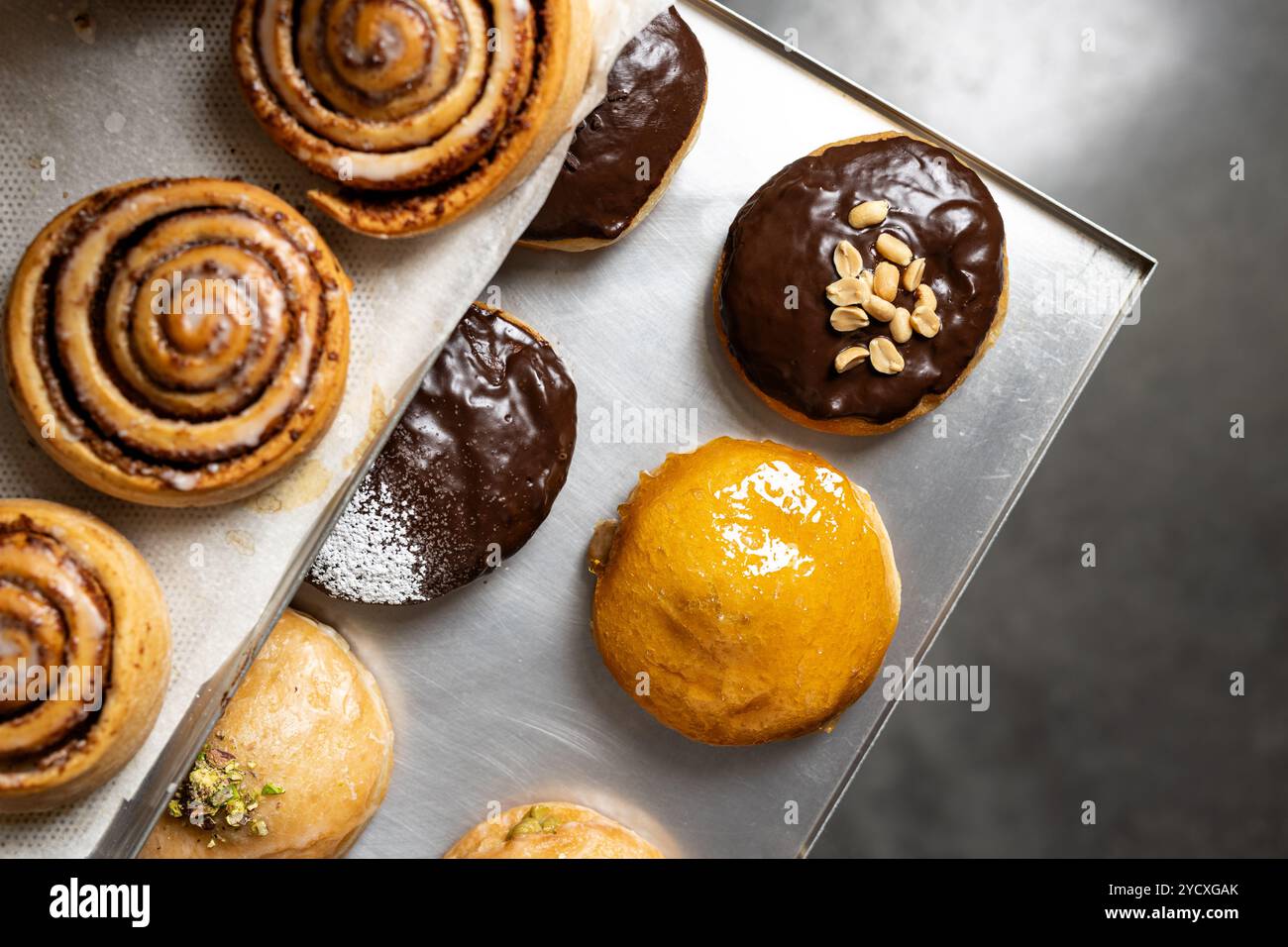 A top view of various freshly baked pastries, including cinnamon rolls ...