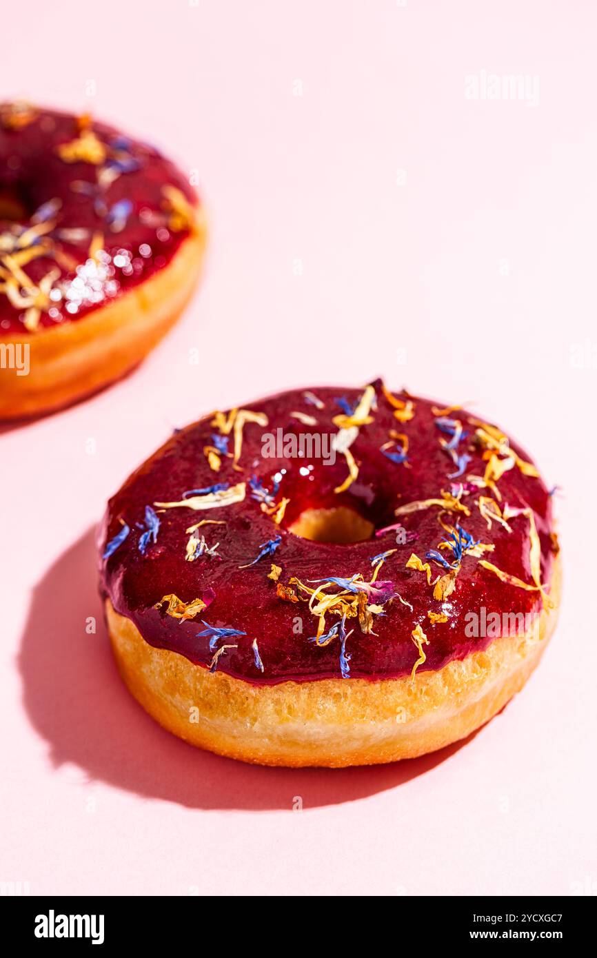 Colorful vegan donuts glazed with a rich red fruit topping and ...