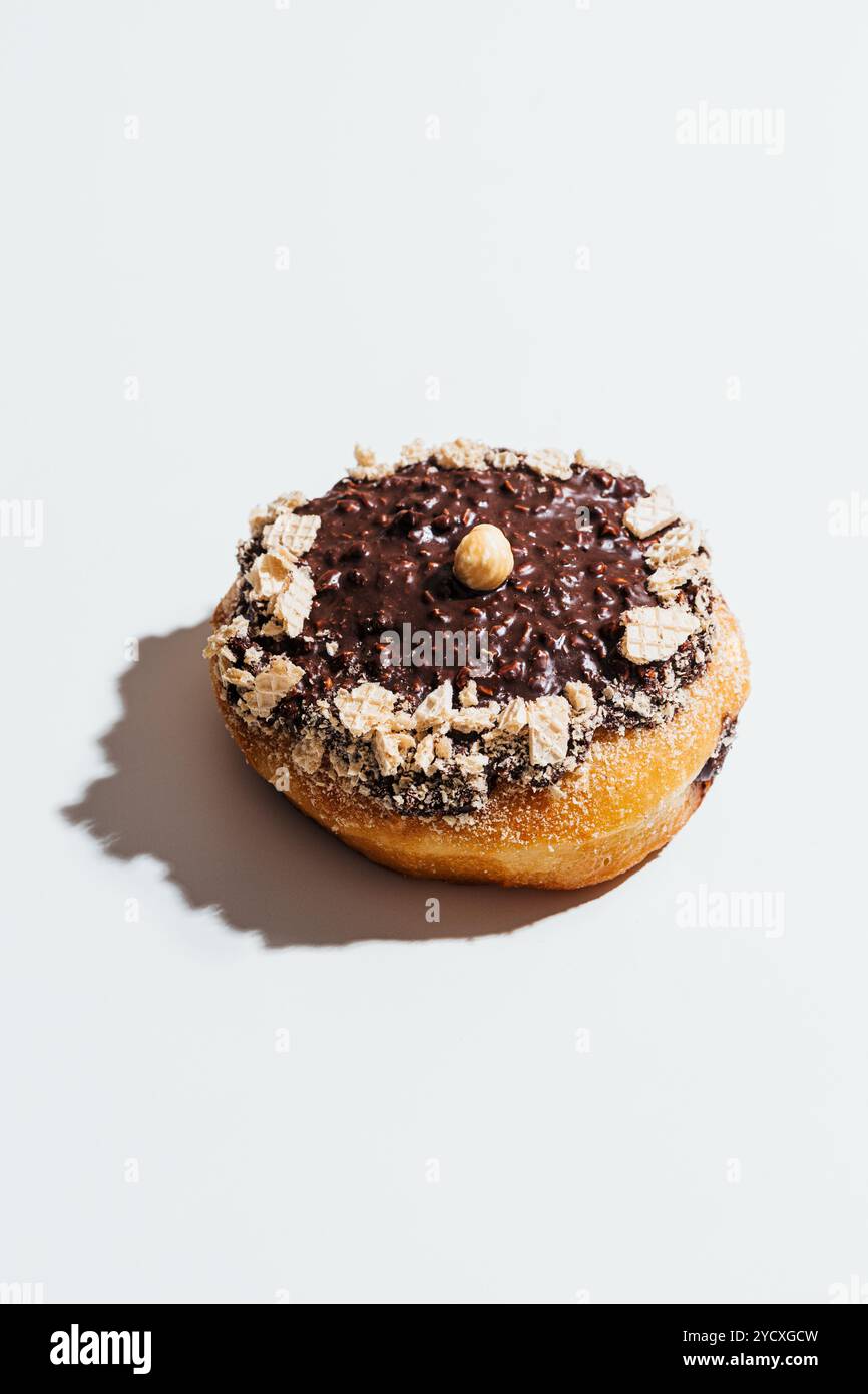 A richly decorated vegan chocolate cream donut topped with a lush ...