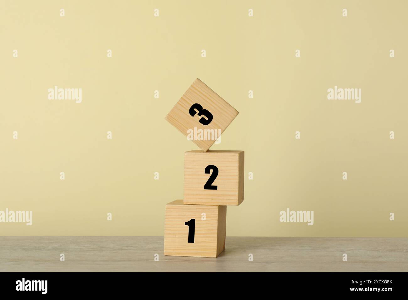 Wooden cubes with numbers 1, 2, 3 on beige background. Step-by-step ...