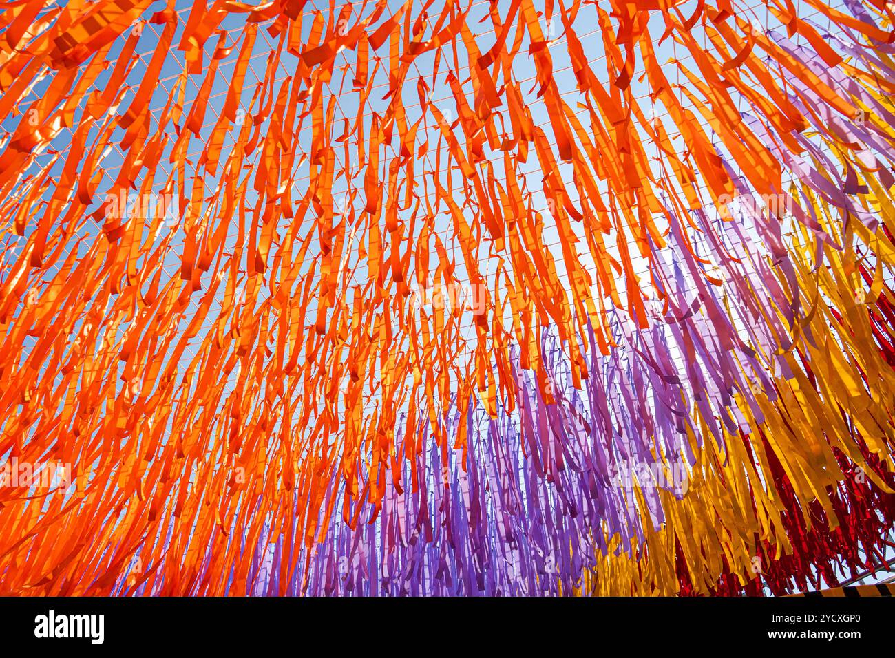 A stunning overhead installation of orange, purple, and yellow ribbons ...