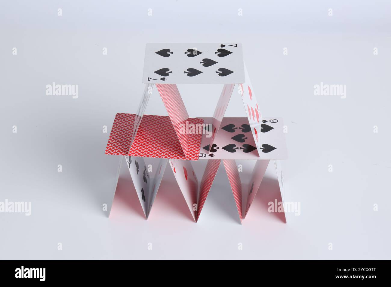 House of playing cards on white background Stock Photo - Alamy