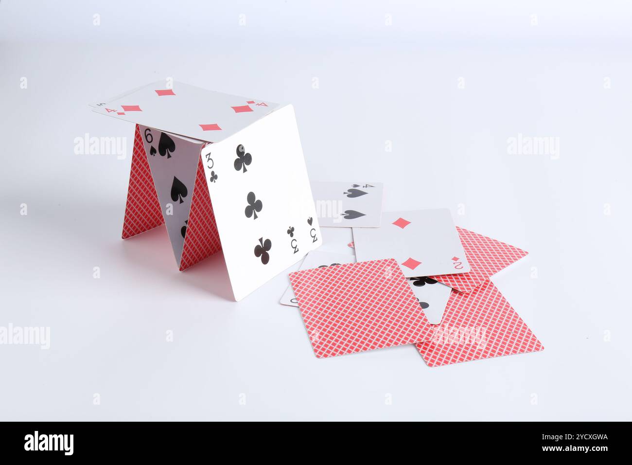 Collapsed house of playing cards on white background Stock Photo - Alamy