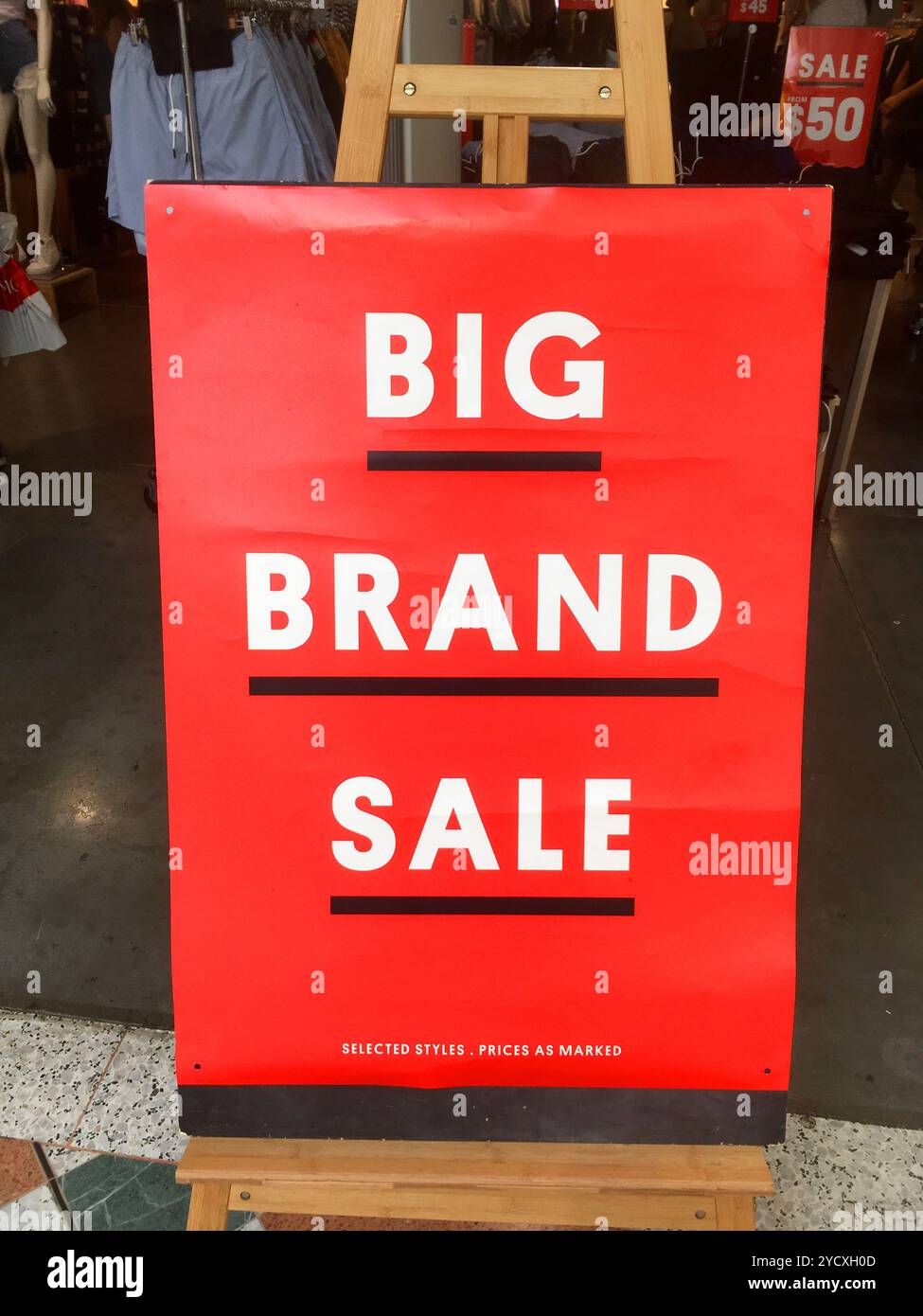 Sale sign out the front of a retail clothing shop Stock Photo - Alamy