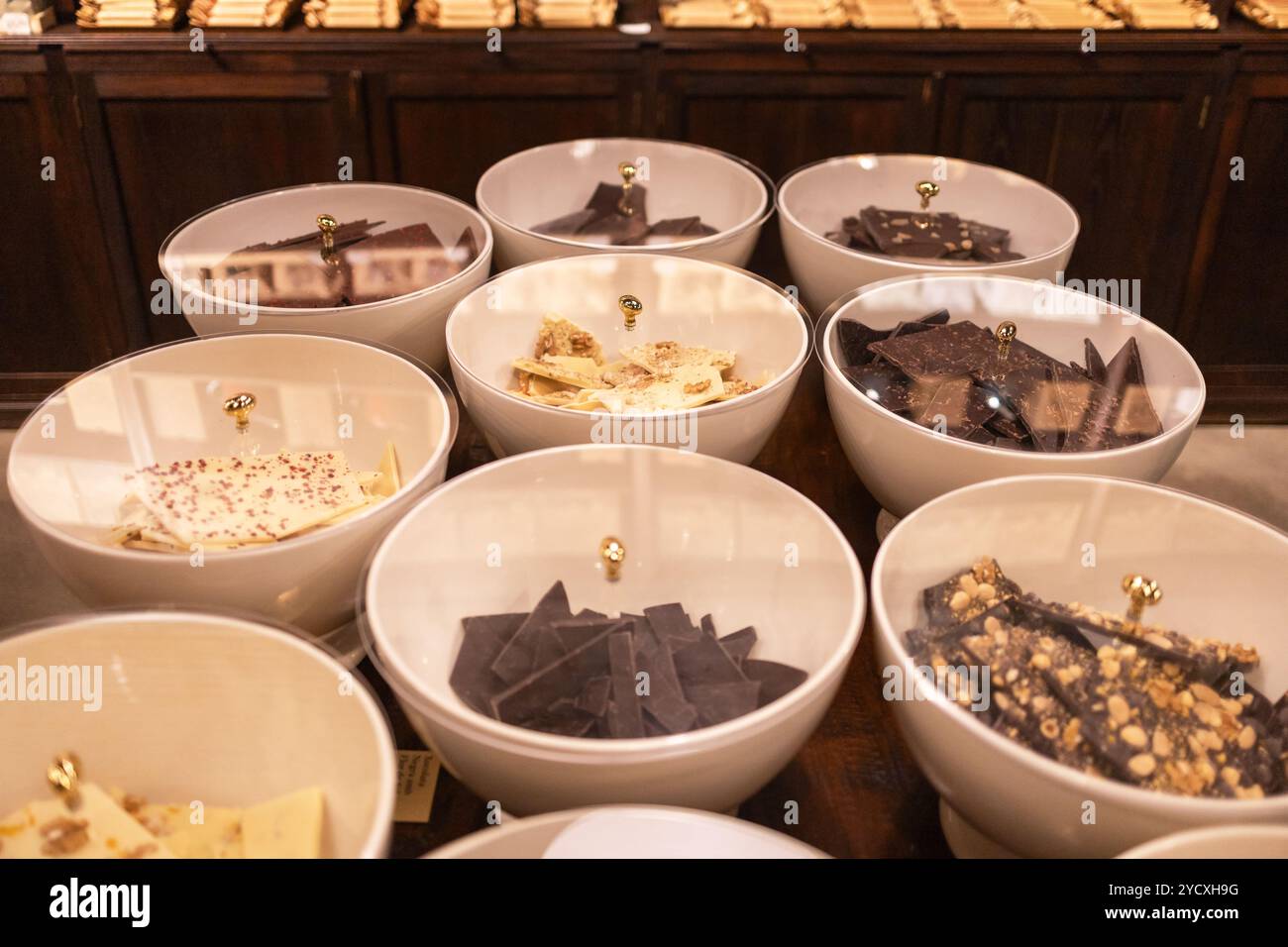 Bowls of assorted premium chocolate pieces displayed in a chocolate ...