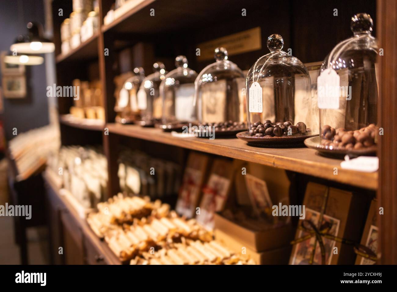 Elegant chocolate store featuring shelves with glass jars filled with ...