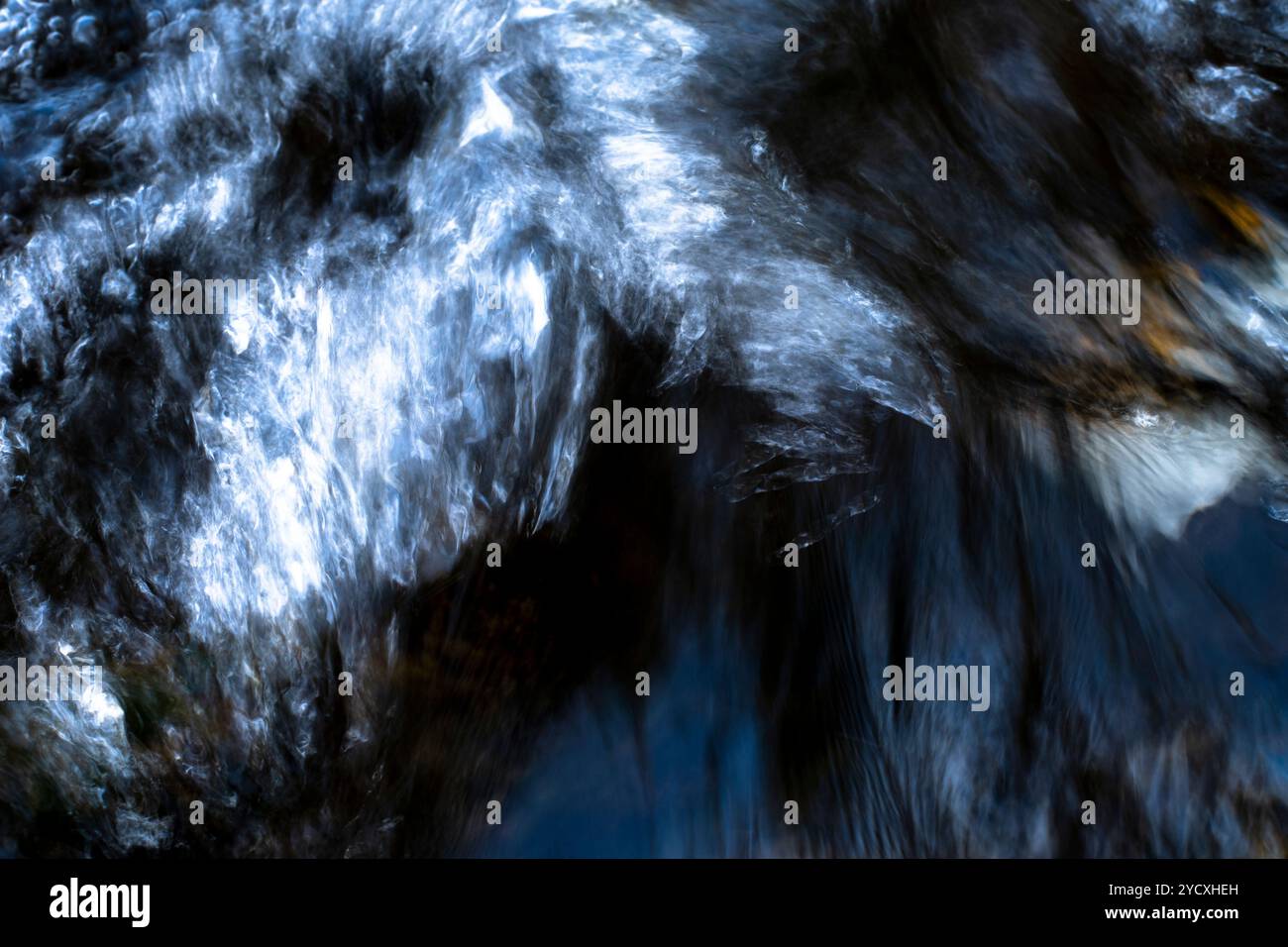 An abstract, flowing water texture captured in motion, creating a ...