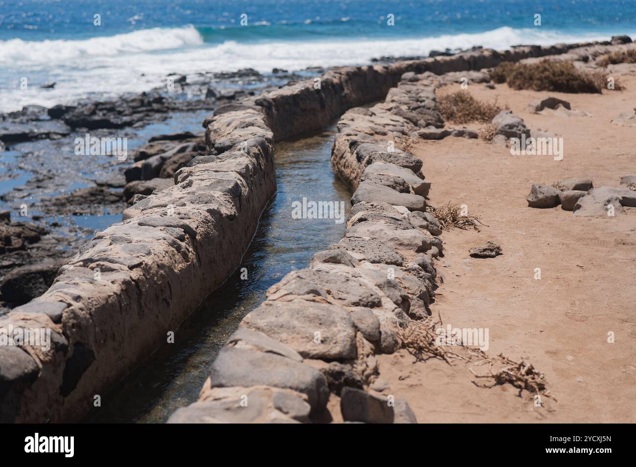 A detailed view of ancient seawater channels carved out of rock, used ...