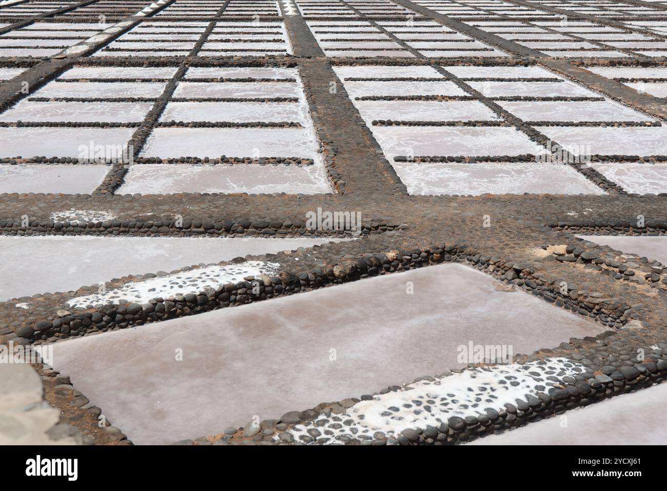 Aerial view of salt evaporation ponds neatly arranged in a grid ...