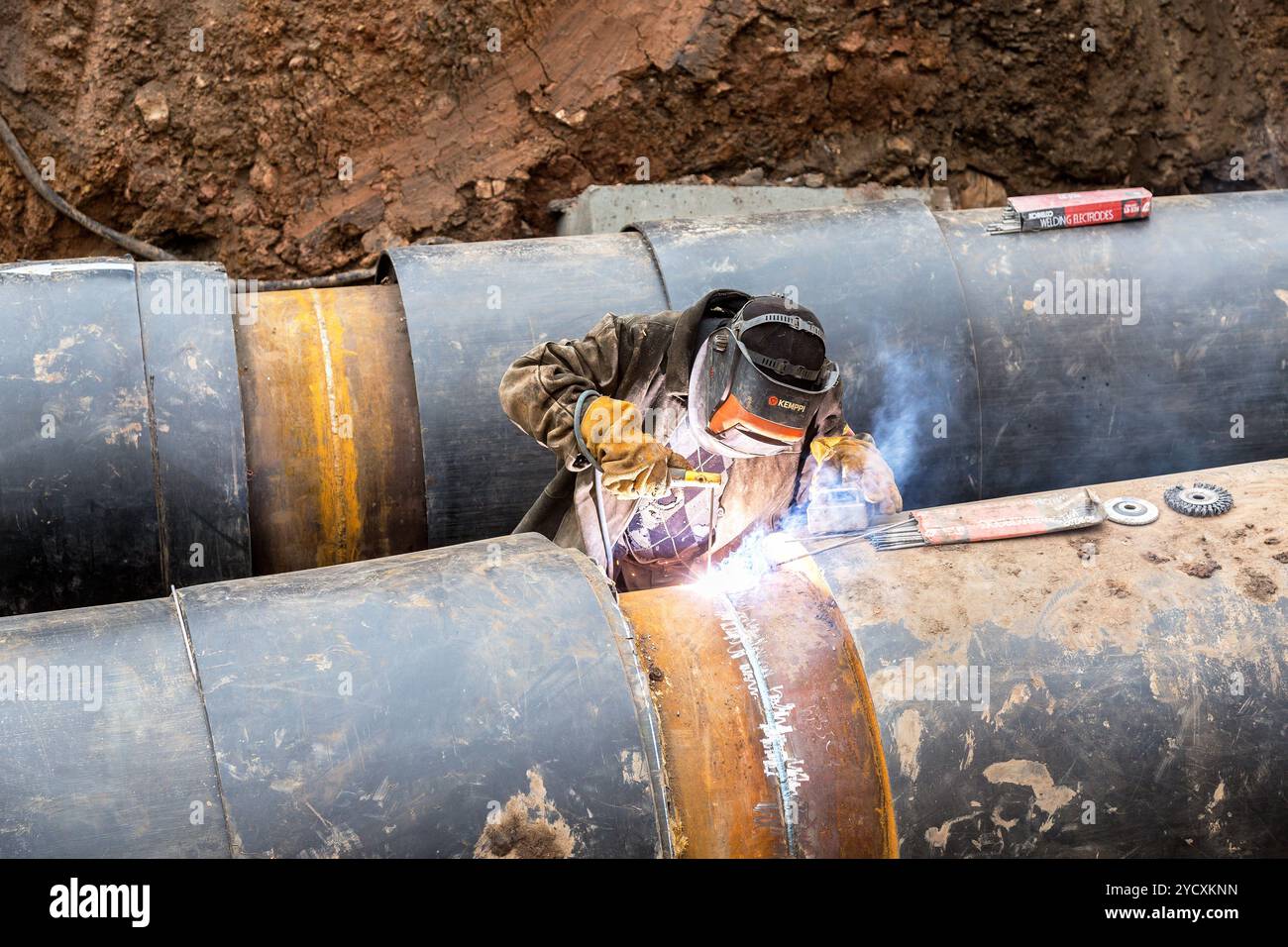 Worker with protective mask welding metal with sparks and smoke Stock ...