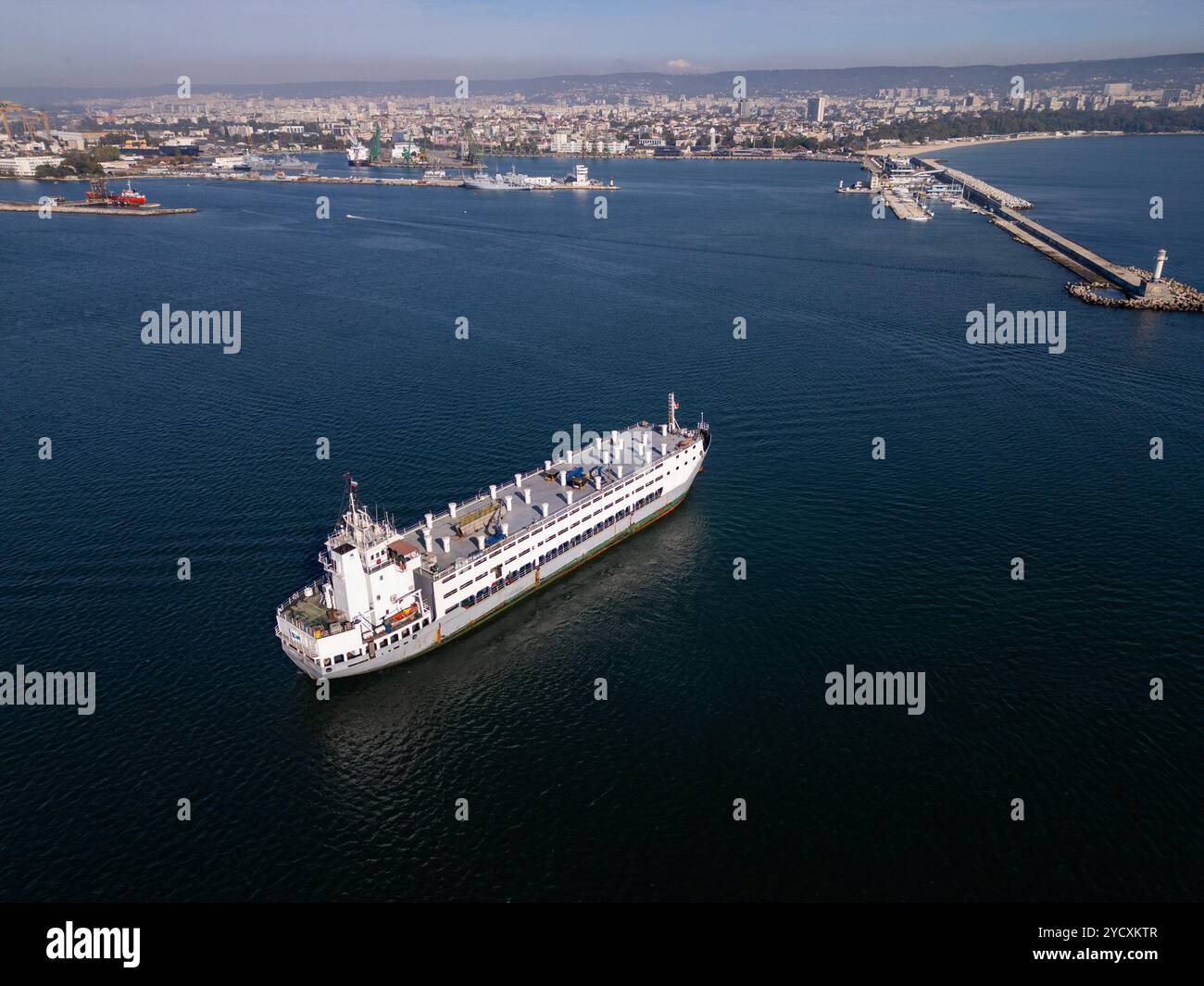 Aerial view of a large cargo ship cruising through calm waters ...