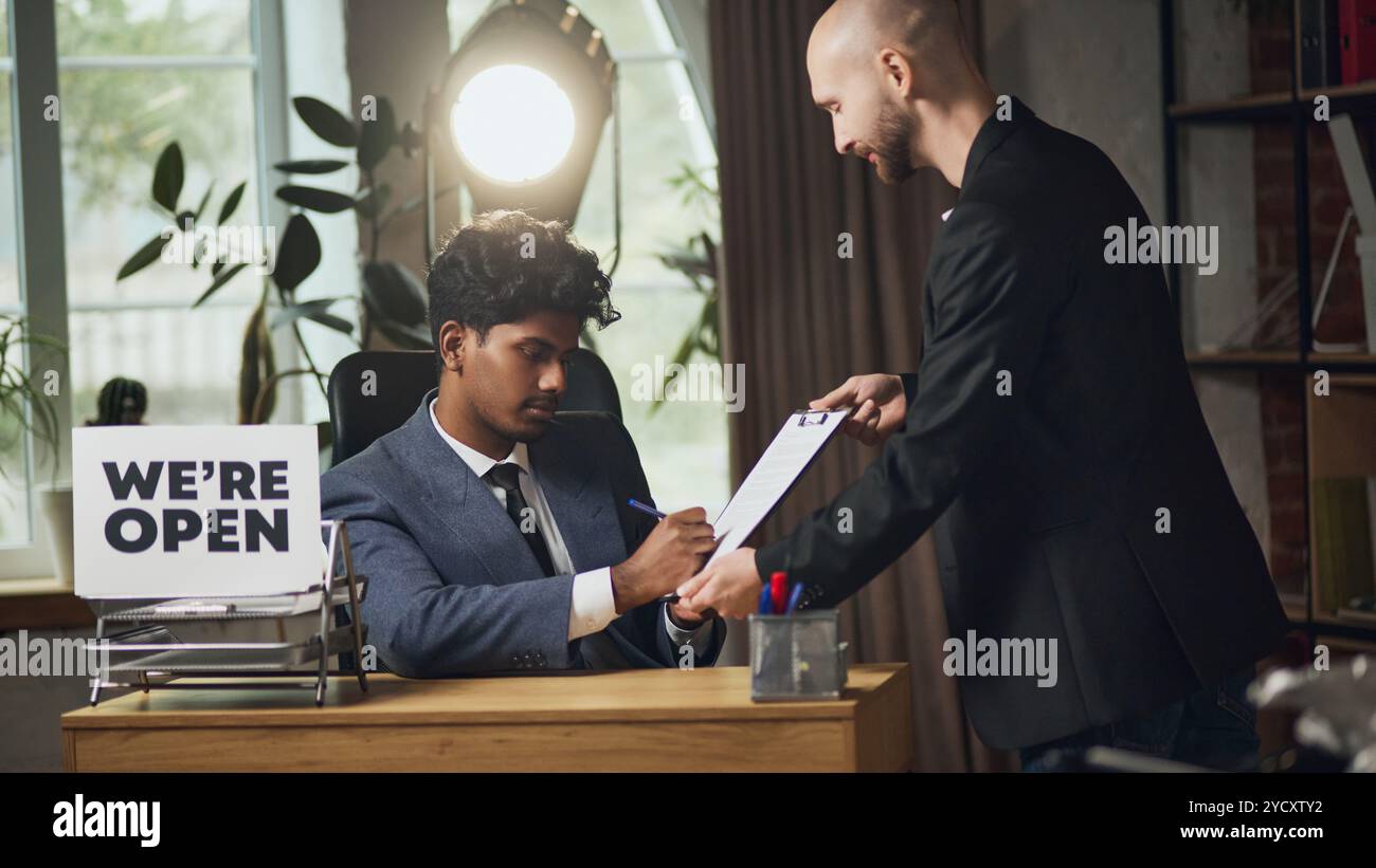 Indian businessman signing document hi-res stock photography and images ...