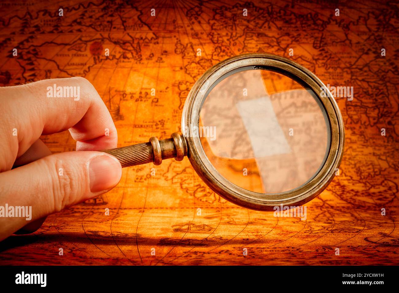 Vintage magnifying glass lies on an ancient world map Stock Photo - Alamy