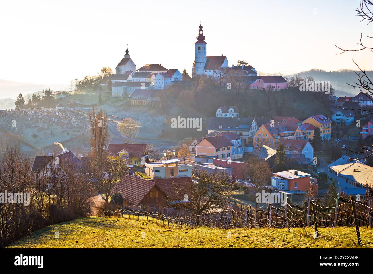 Straden village in fog church on the hill Stock Photo - Alamy