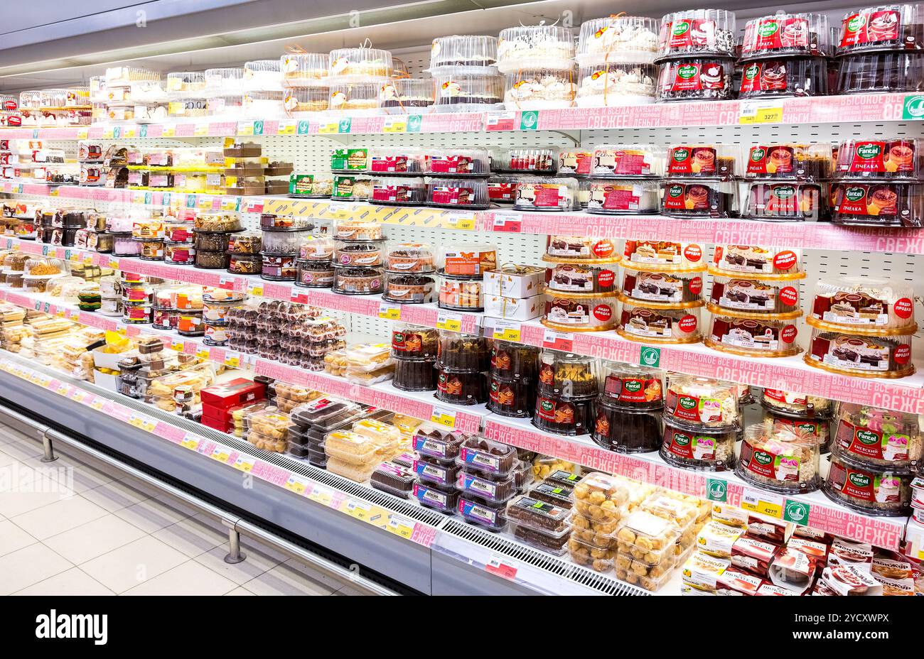 Showcase with different fresh sweet cakes ready to sale in hypermarket ...