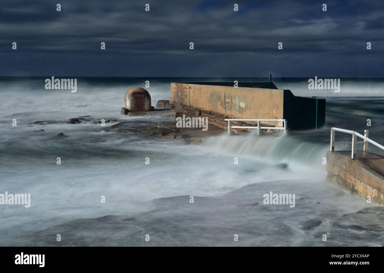 Newcastle Ocean Baths underwater in large swell Stock Photo - Alamy