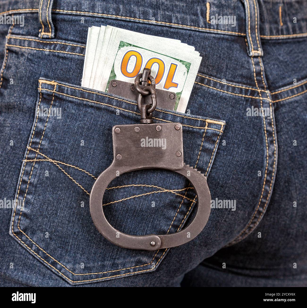 Police metal handcuffs and american currency in back jeans pocket Stock ...