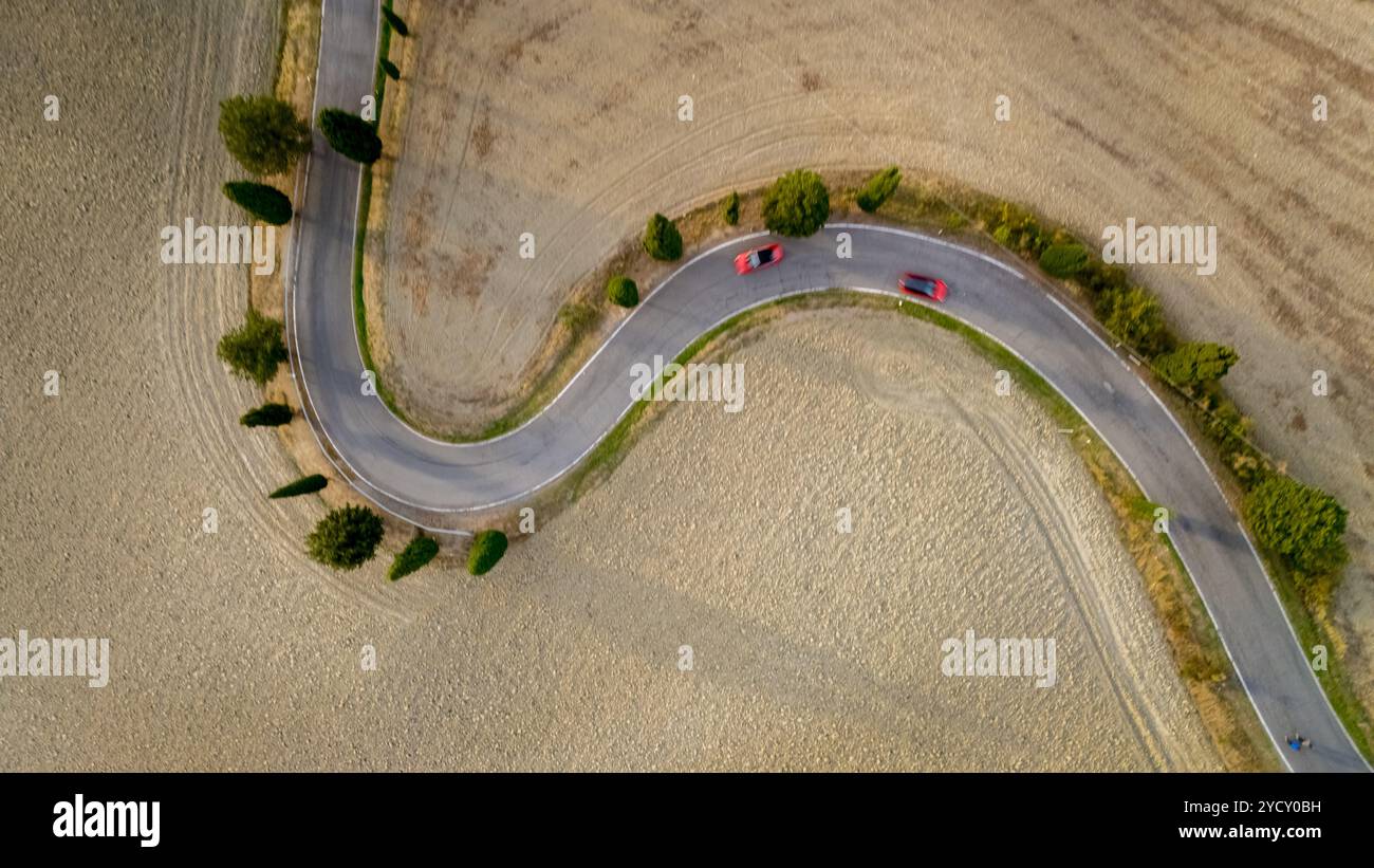 Curved roads meander through the golden fields of Tuscany, where ...