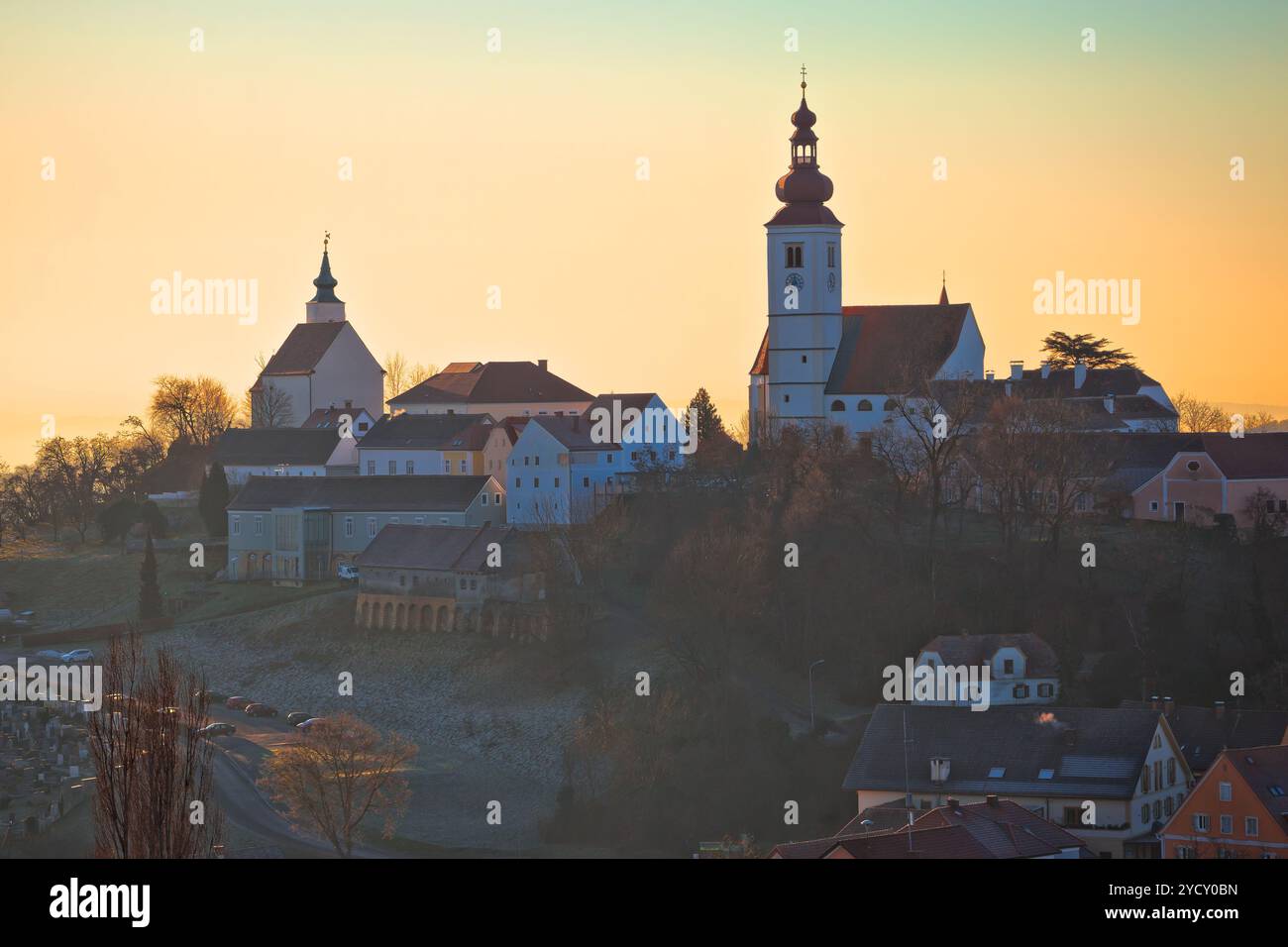 Straden village in fog church on the hill Stock Photo - Alamy