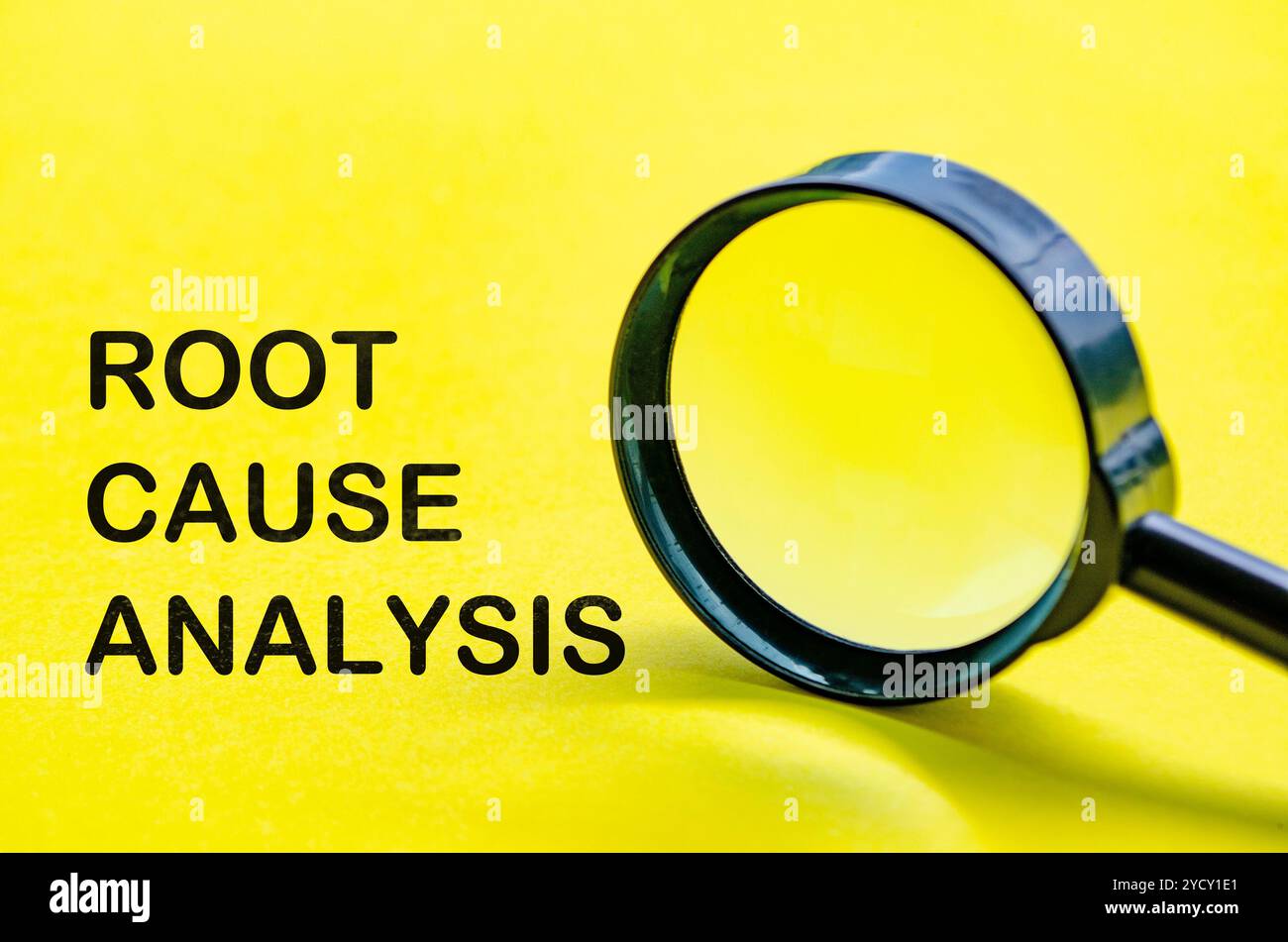 Root Cause Analysis text on yellow cover with magnifying glass ...