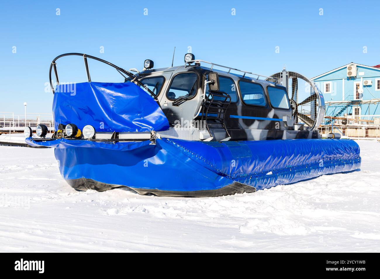 Passenger hovercraft transporter on the ice of river in winter day ...