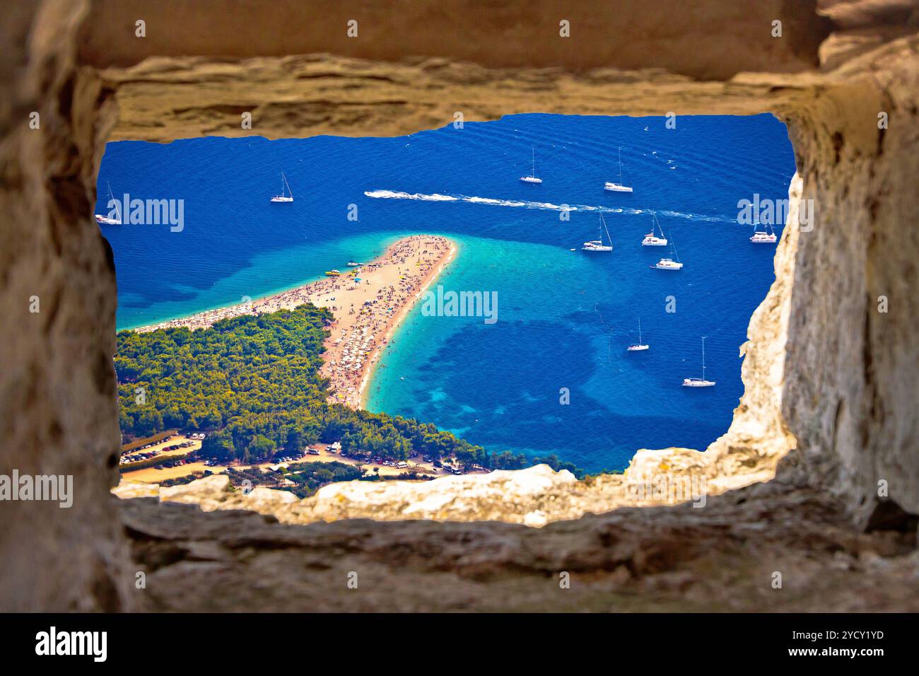 Zlatni rat beach aerial view through stone window Stock Photo - Alamy