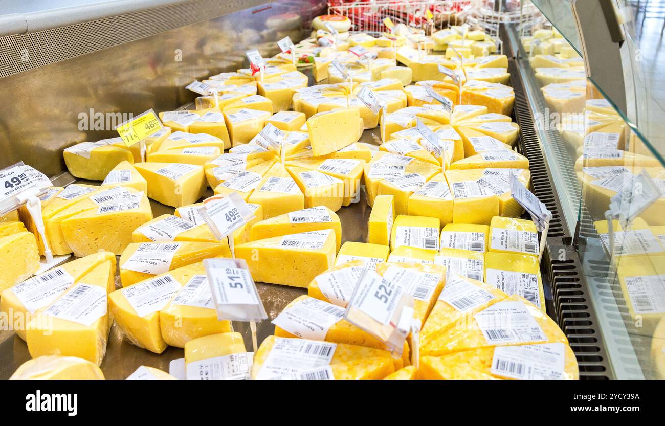 Tasty freshly cheese ready to sale in the showcase at the supermarket ...