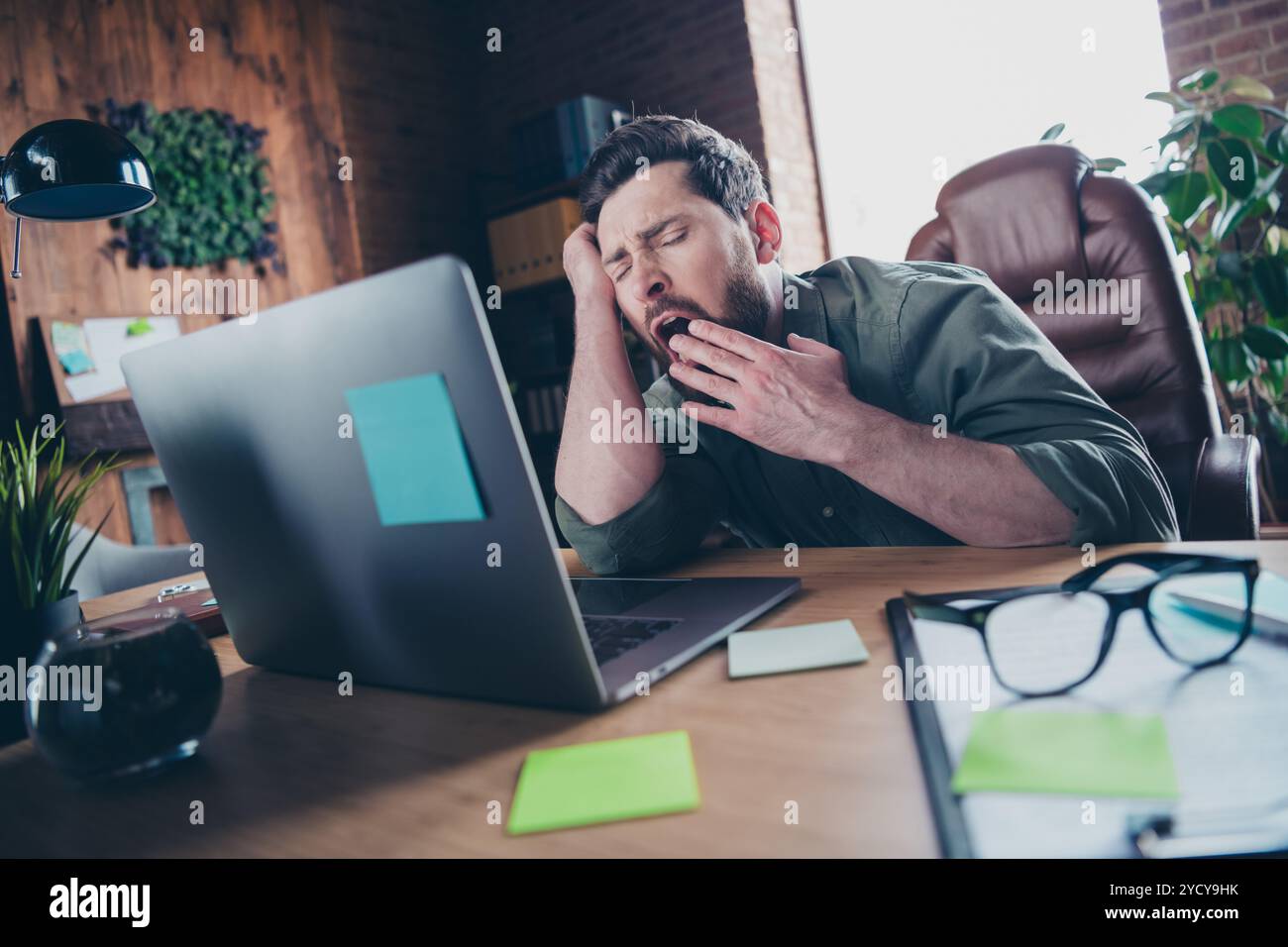 Photo of attractive young man tired freelancer yawning sleepy wear ...