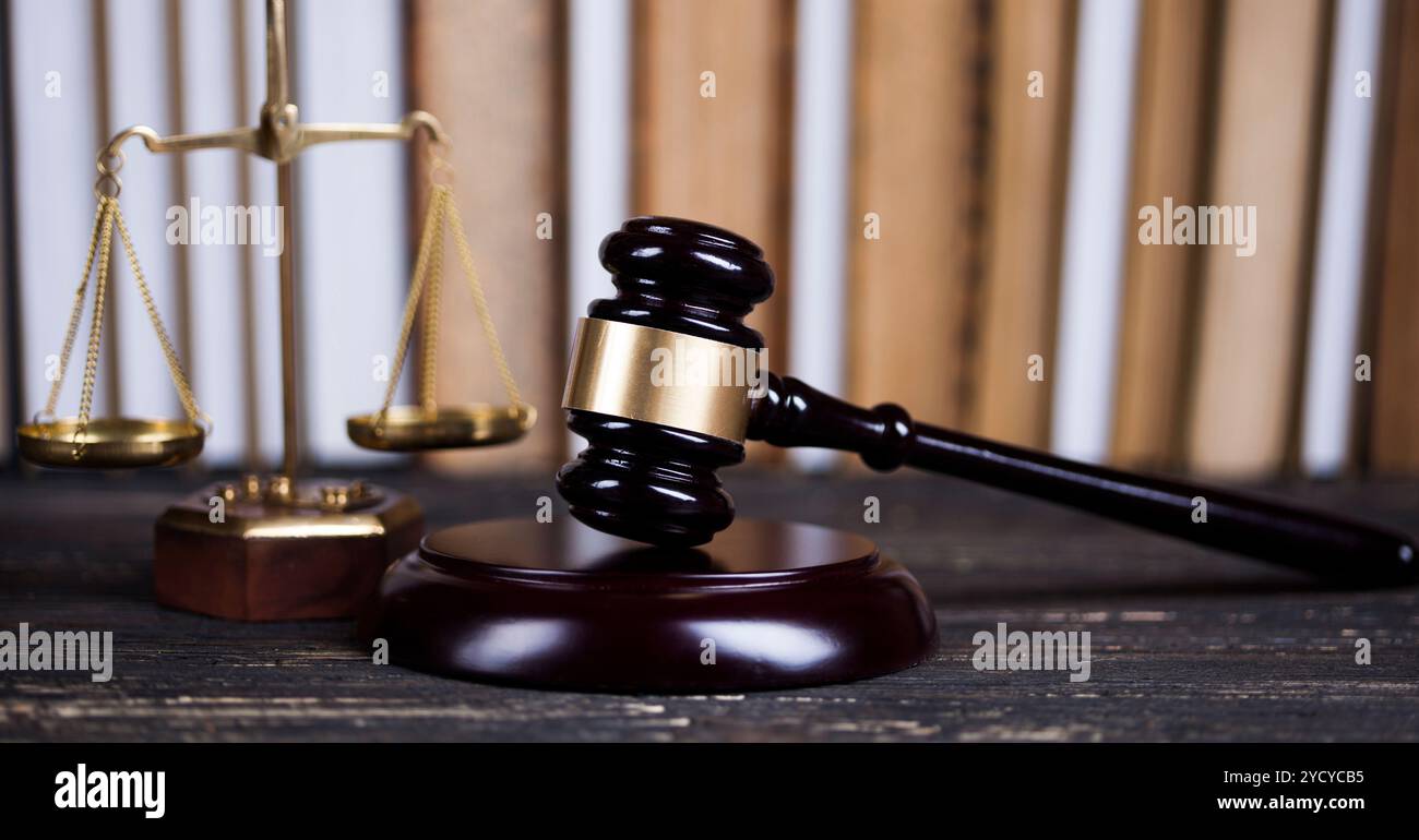 Law book, mallet of the judge, justice scale, wooden desk background ...