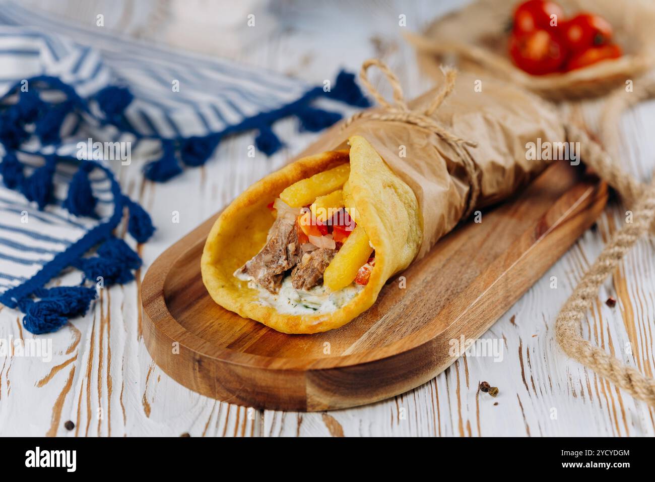 Juicy gyro wrap with fries, vegetables, and sauce, perfect for ...