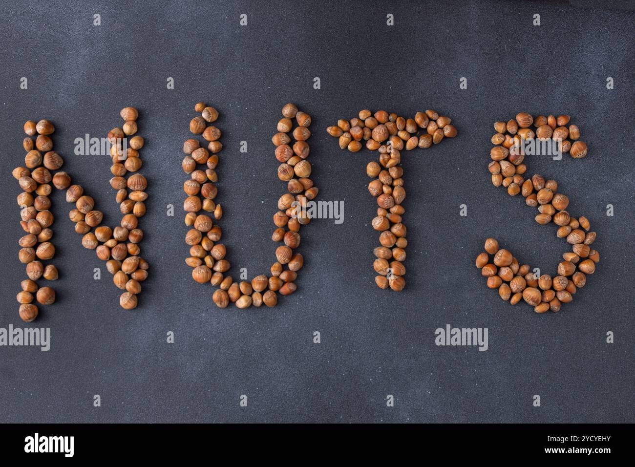 Word text Nuts. Hazelnut food. Kernel raw seed. Hazel nut Stock Photo - Alamy