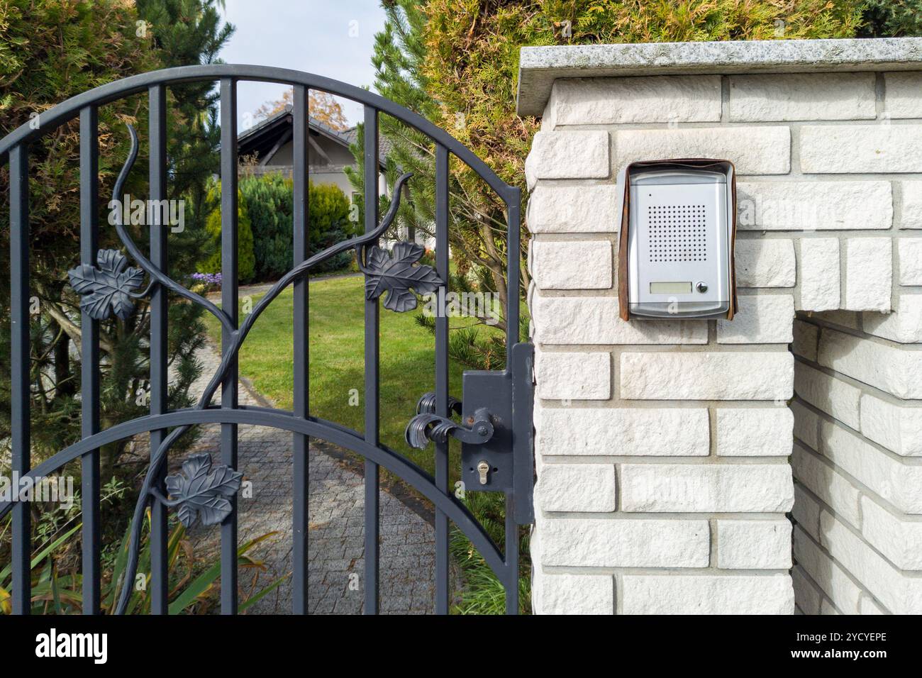 Decorative Metal Gate with Intercom and Brick Wall Stock Photo - Alamy