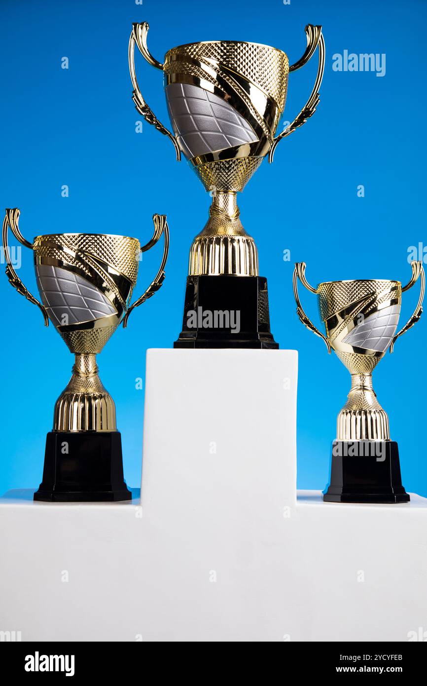 Sport podium, Cups of winners award Stock Photo - Alamy
