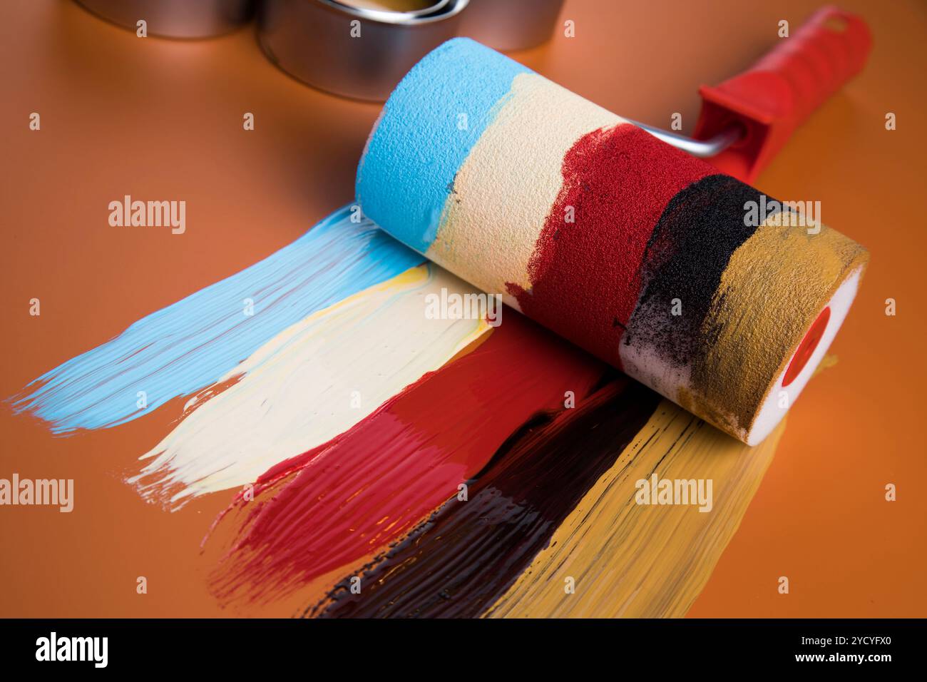 Paint roller, cans with color Stock Photo - Alamy