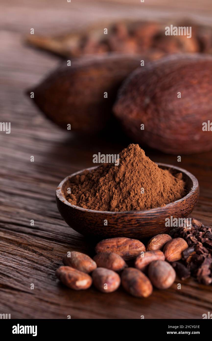 Cocoa beans in the dry cocoa pod fruit on wooden background Stock Photo ...