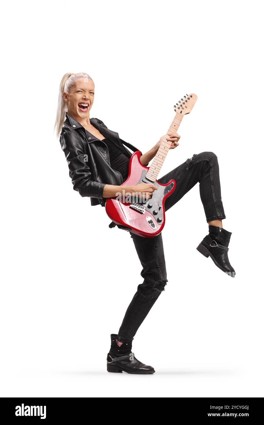 Female rock musician playing a guitar and dancing isolated on white ...