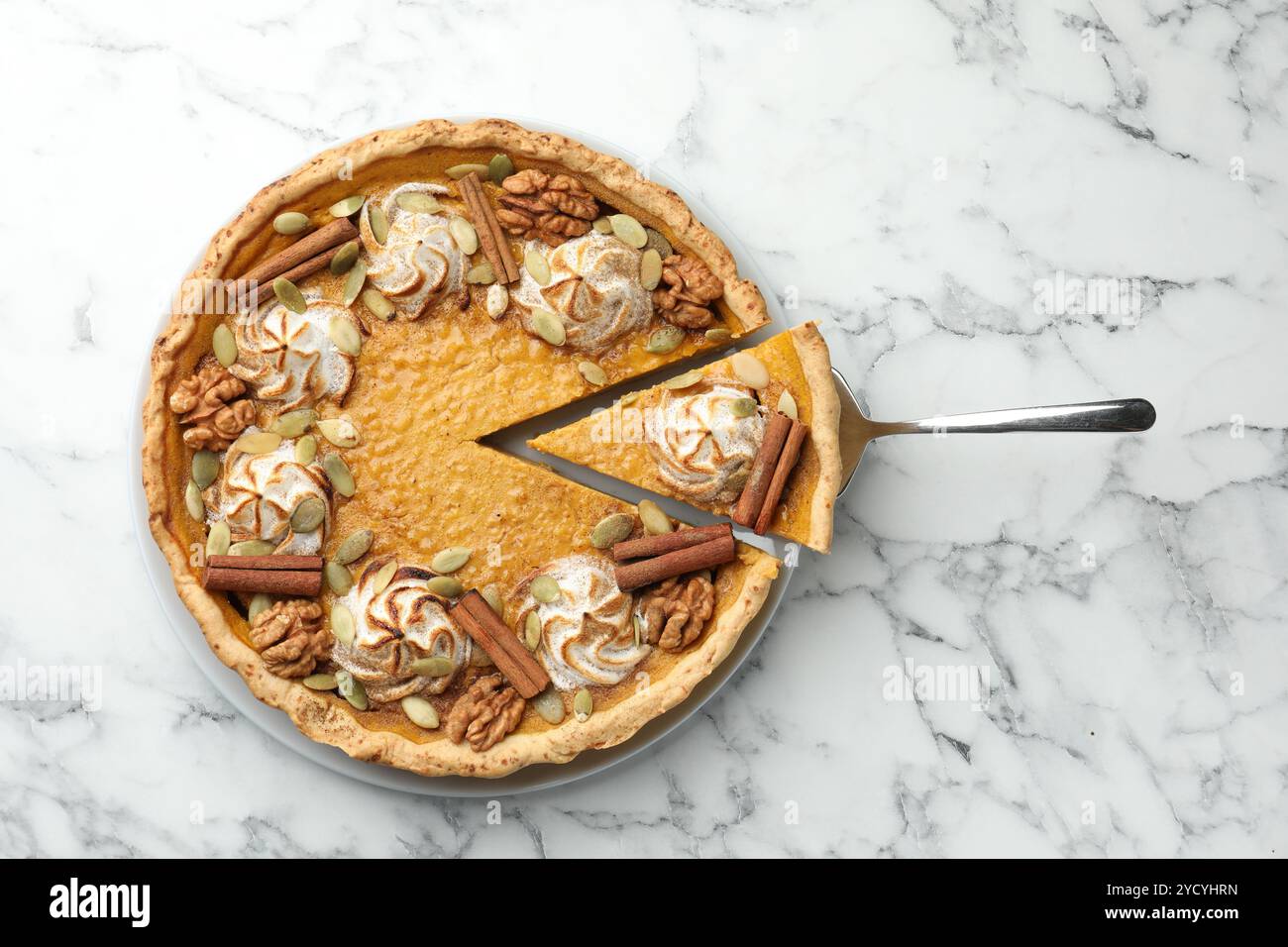 Tasty homemade pumpkin pie with server on white marble table, top view ...