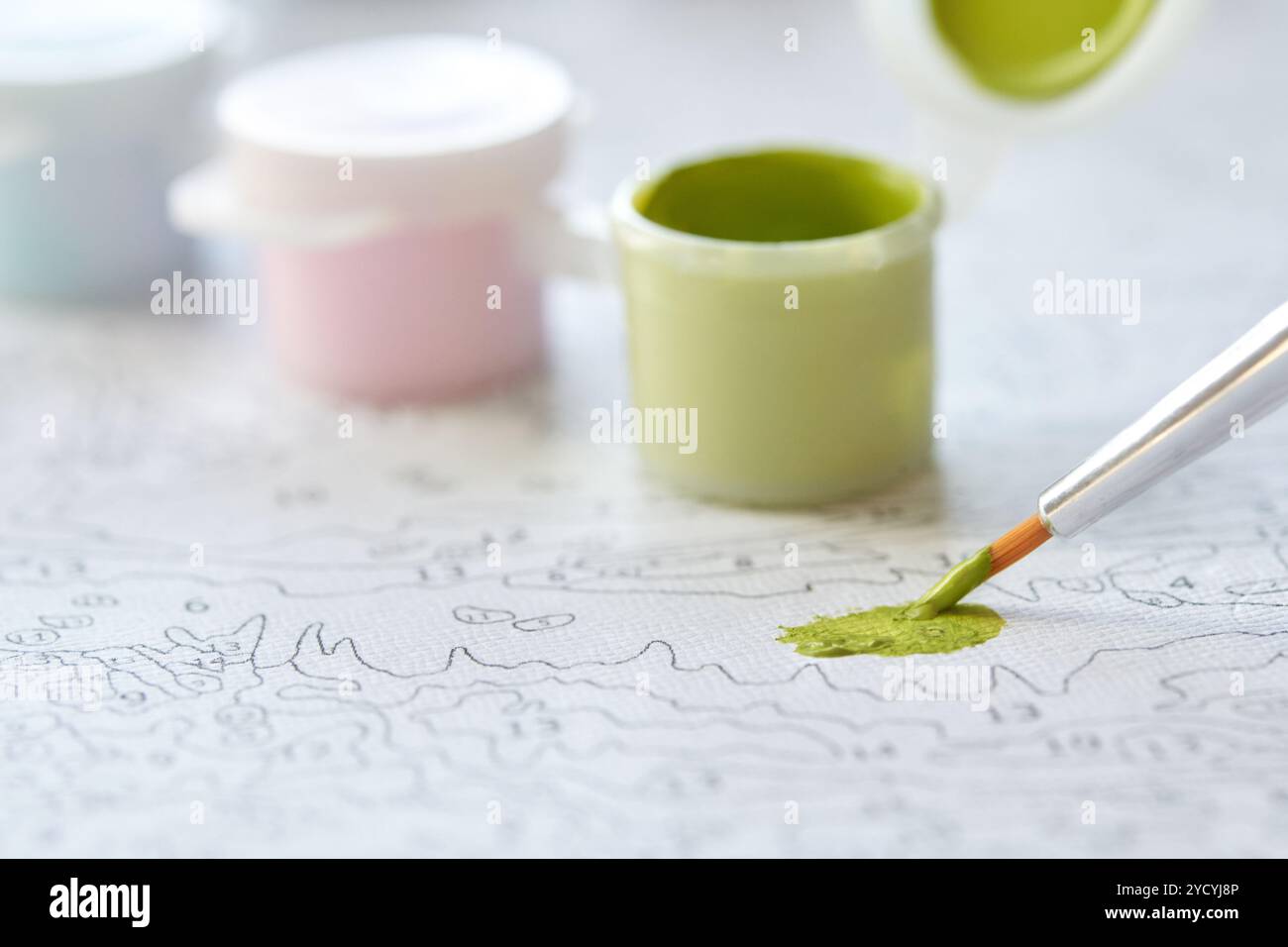 Artistic journey: painting by numbers with green paint on canvas for ...