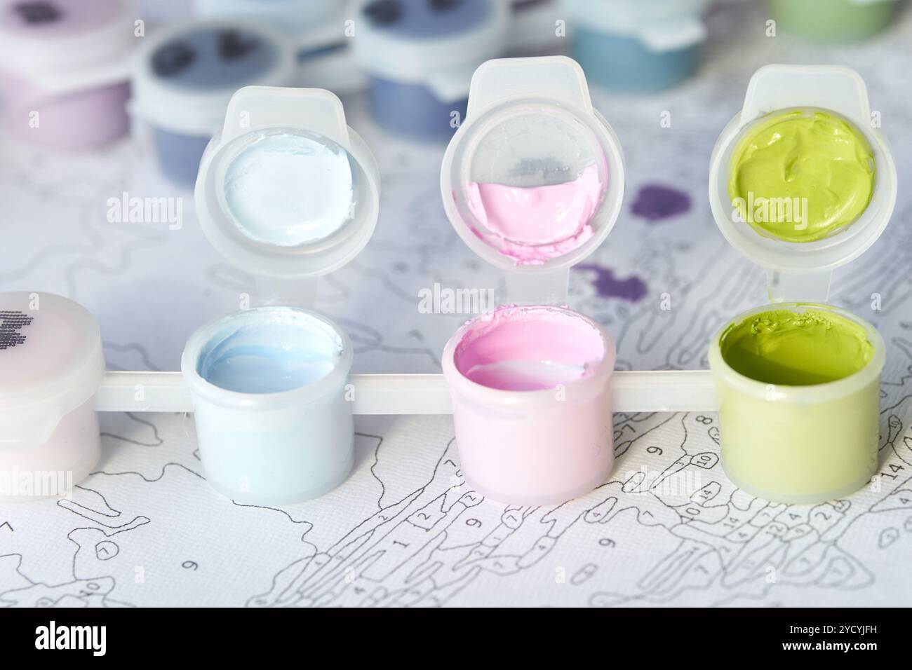 Vibrant paint containers on detailed map surface: colorful art supplies ...